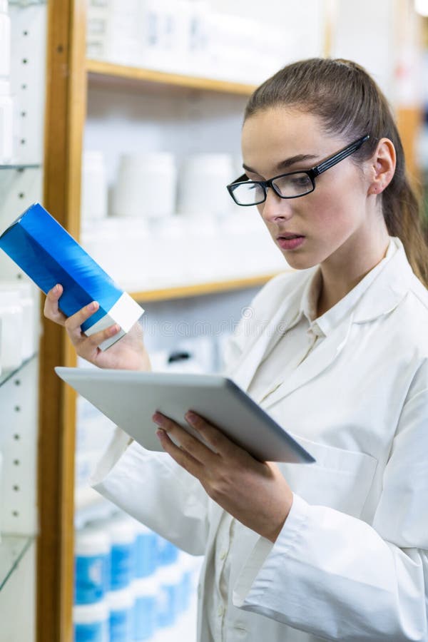 Pharmacist Using Digital Tablet while Checking Medicine Stock Image ...