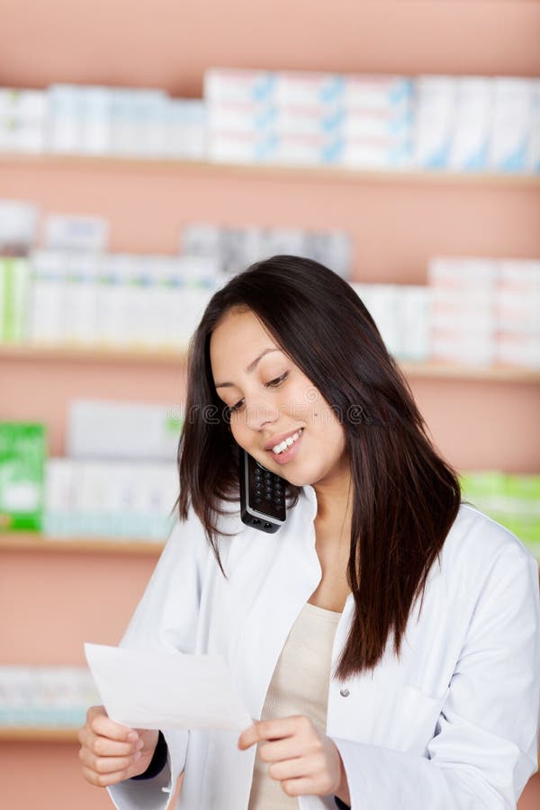 Pharmacist Using Phone in Pharmacy Stock Image - Image of people, focus ...