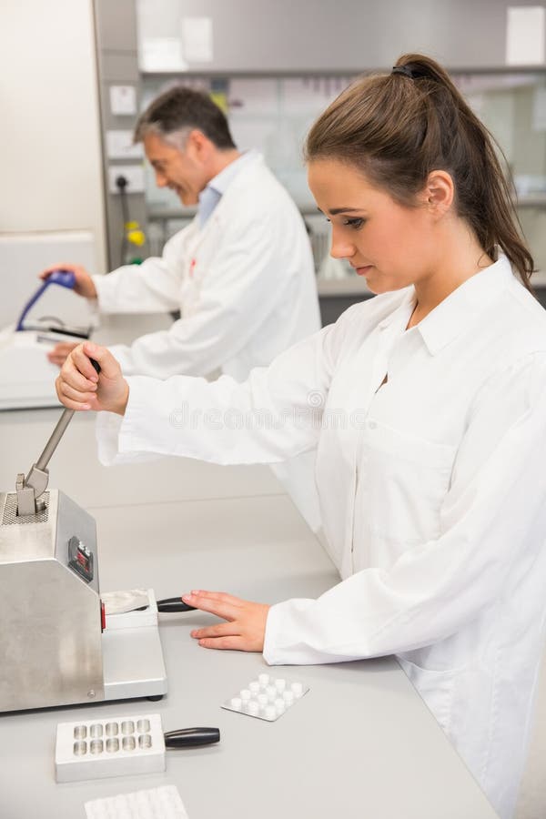 Pharmacist Using Press To Make Pills Stock Photo - Image of laboratory ...