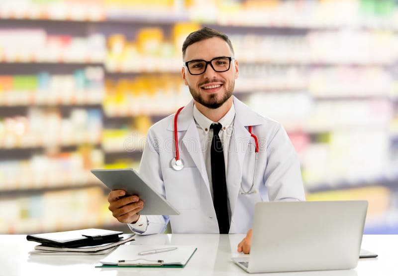 Pharmacist Using Tablet Computer at Pharmacy Stock Image - Image of ...