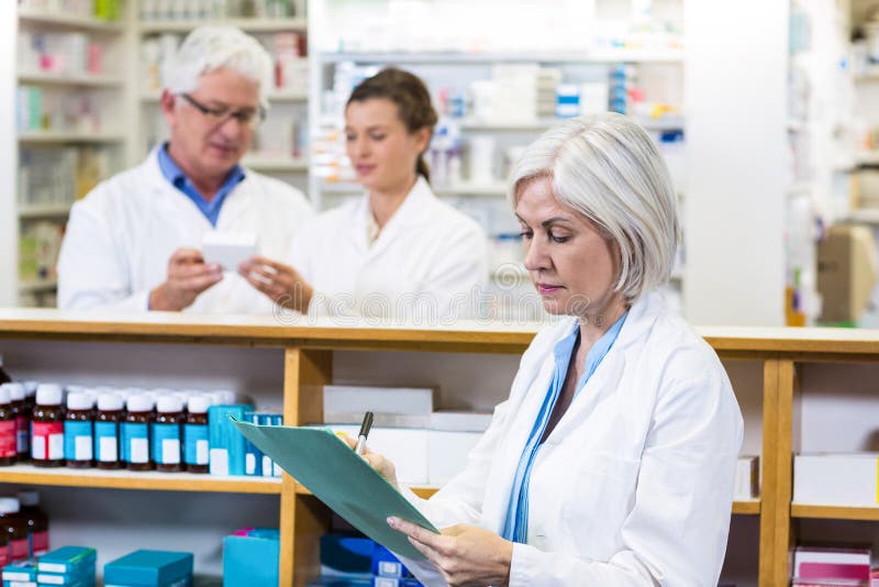 Pharmacist Writing on Clipboard Stock Photo - Image of expertise ...