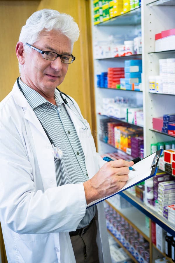 Pharmacist Writing on Clipboard Stock Image - Image of male, camera ...