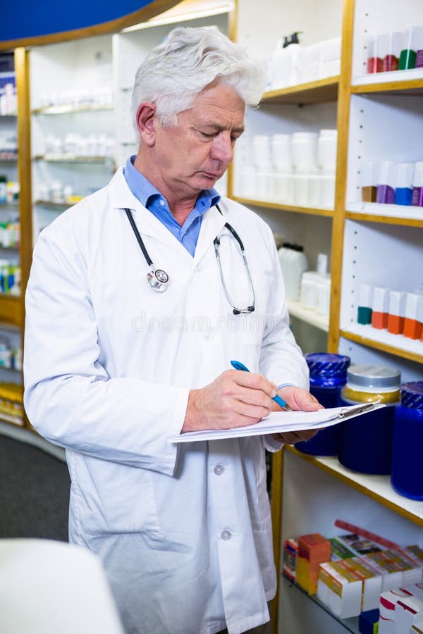 Pharmacist Writing on Clipboard Stock Image - Image of focused ...