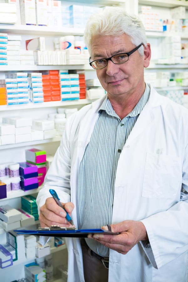 Pharmacist Writing on Clipboard in Pharmacy Stock Photo - Image of drug ...