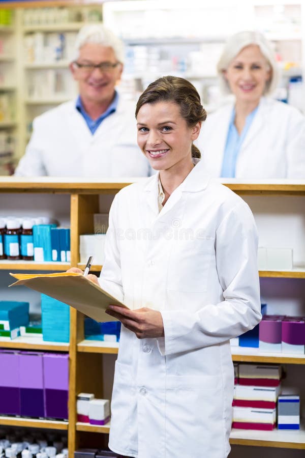 Pharmacist Writing on File in Pharmacy Stock Photo - Image of male ...