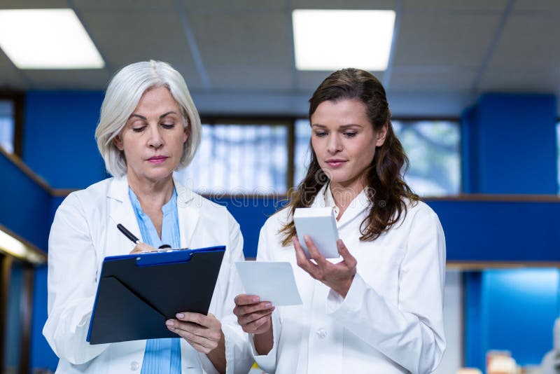 Pharmacists Checking and Writing Prescription for Medicine Stock Photo ...