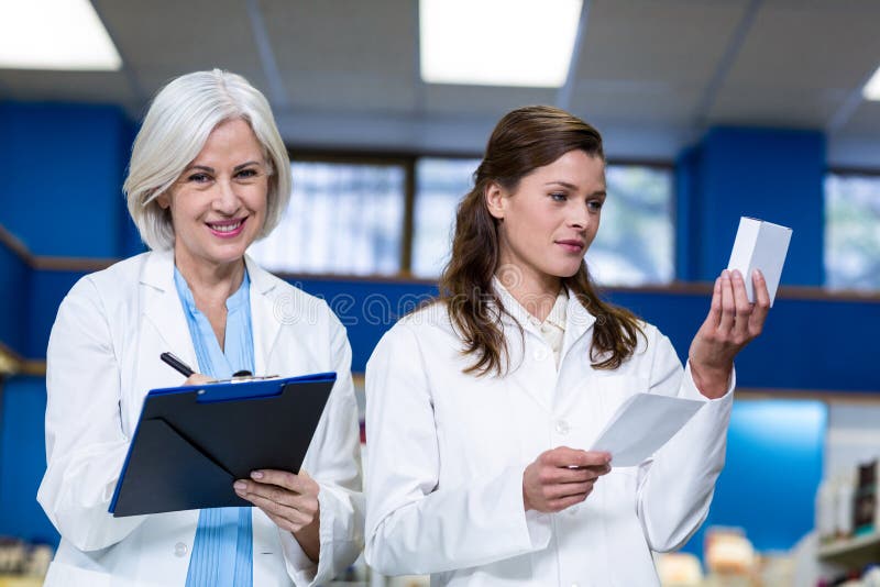 Pharmacists Checking Medicines on Shelf in Pharmacy Stock Photo - Image ...