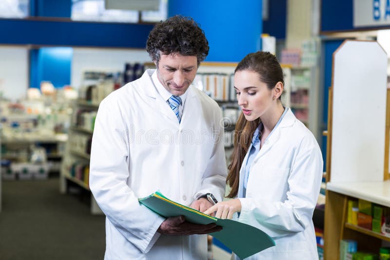 Pharmacists Discussing Over Medical Report Stock Photo - Image of ...