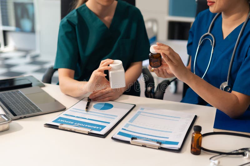 Pharmacists or Doctors Study Information about Tablets in the Room ...