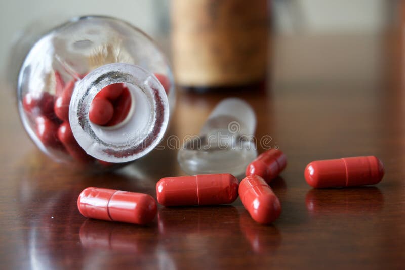 Pharmacy red capsules stock image. Image of table, medicine - 242123237