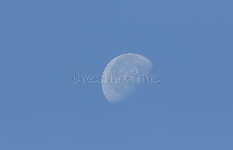 A Phase of the Moon Against a Blue Sky in the UK. Stock Image - Image ...
