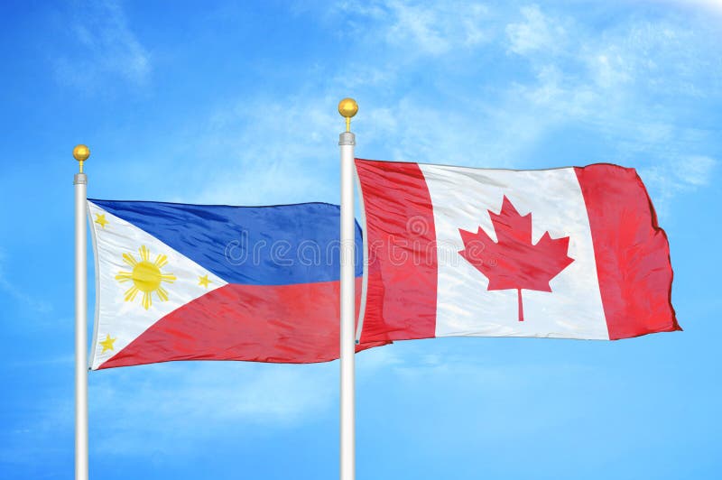 Philippines And Canada Two Flags On Flagpoles And Blue Cloudy Sky Stock ...