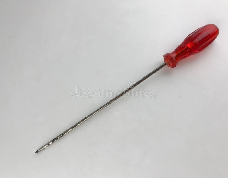 A Phillips-shaped Screwdriver with a Red Plastic Handle Placed on a ...