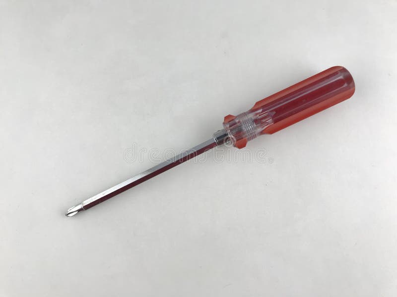 A Phillips-shaped Screwdriver with a Red Plastic Handle Placed on a ...