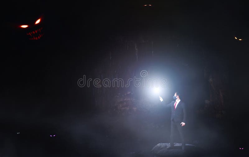 A Man in a Dark Cave with Light Against Monsters Stock Image - Image of ...