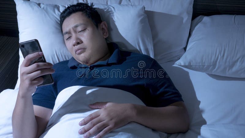 Phone Addicted, Man Using Smart Phone on Bed at Midnight Stock Photo ...
