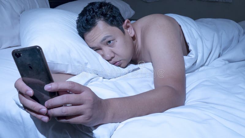 Phone Addicted, Man Using Smart Phone on Bed at Midnight Stock Photo ...
