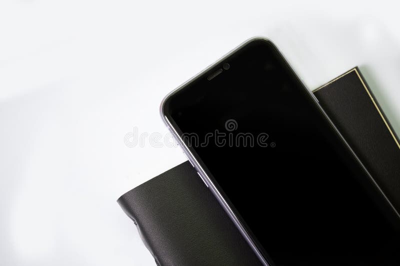 Phone with Black Textured Notebook on a White Background. View from ...