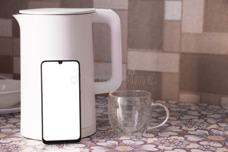 Phone with a Blank White Screen Stands Near a White Teapot and a Cup on ...