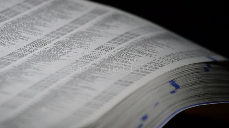 Page of Phone Book with Names and Address Rotating in a Black ...