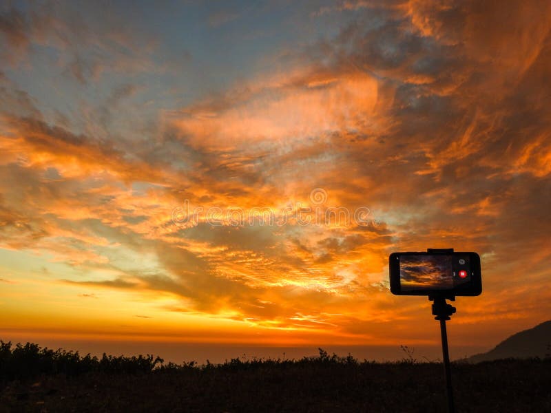 A Phone Capturing Sunset at the Golden Hour Fixed on a Tripod Stock ...