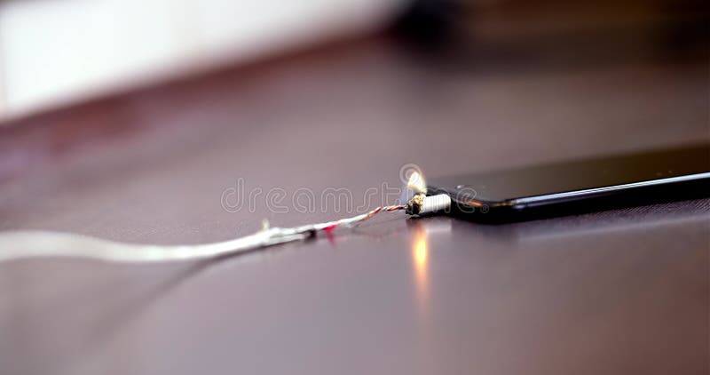 Phone Charging Cable Catches Fire. Danger of Using a Broken Cable Stock ...