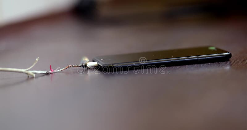 Phone Charging Cable Catches Fire. Danger of Using a Broken Cable Stock ...
