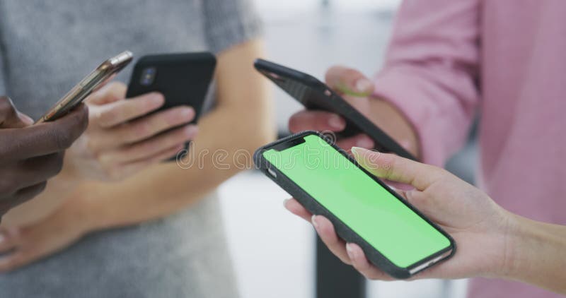 Phone, Data and Green Screen with People Standing in a Huddle To ...
