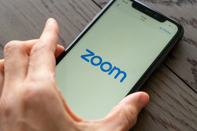 Phone with a Hand Showing Zoom Cloud Meetings App. Editorial ...