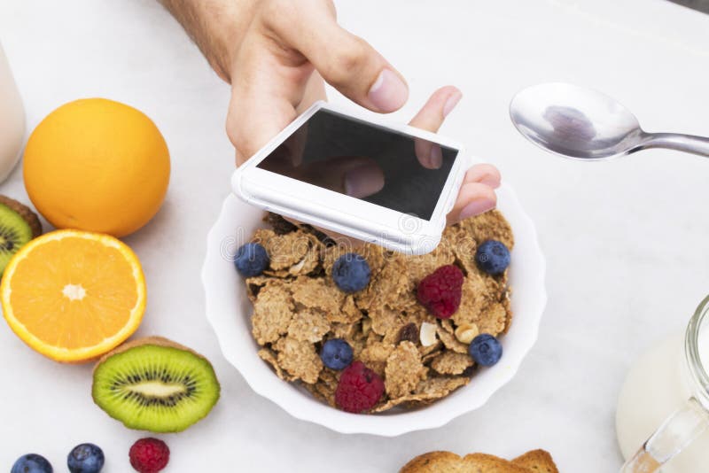 Phone hands at breakfast stock image. Image of food - 136018335