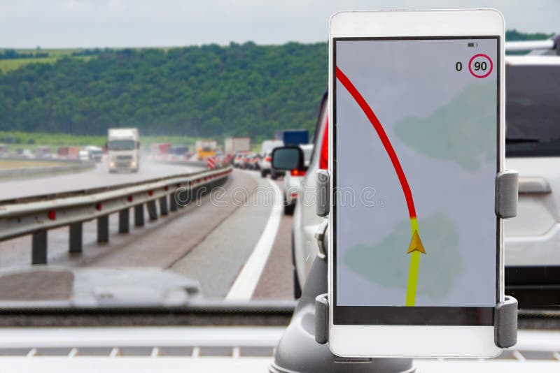 A Phone with a Navigation Program on the Dashboard of a Car in a ...