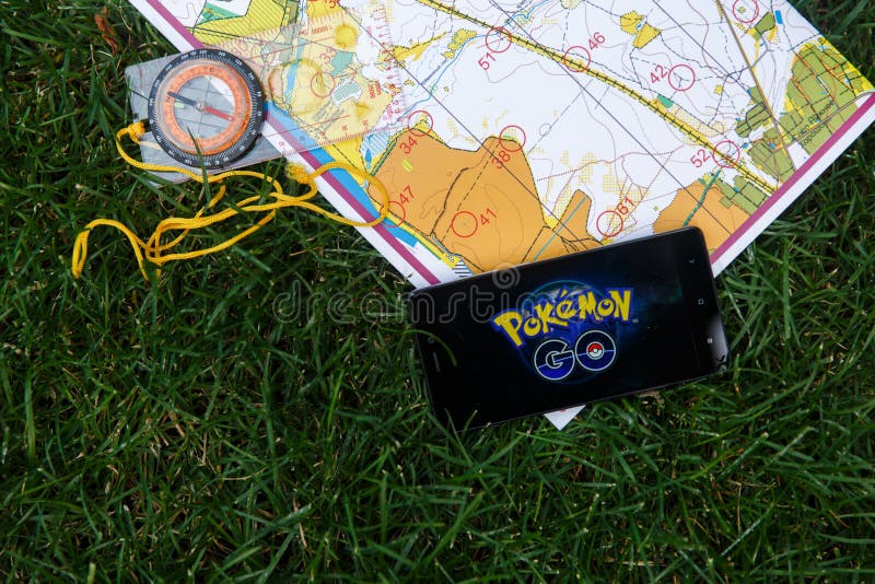 Phone with Pokemon Go Application on Screen, Maps and Compas. Editorial ...