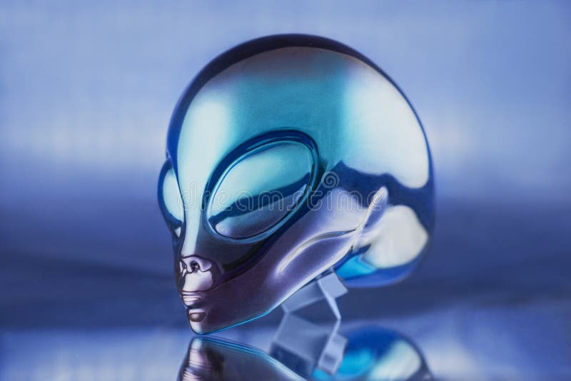 Alien Metal Head Statue on Blue Background on the Table Stock Image ...