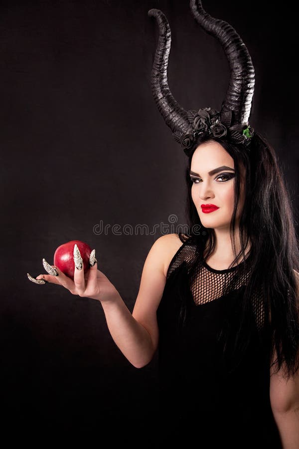 An Apple in the Hands of a Horned Witch Stock Photo - Image of brunette ...