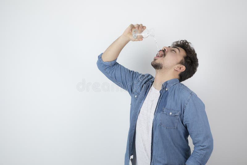 Photo of an Attractive Man Standing and Drinking from a Glass Jar Stock ...