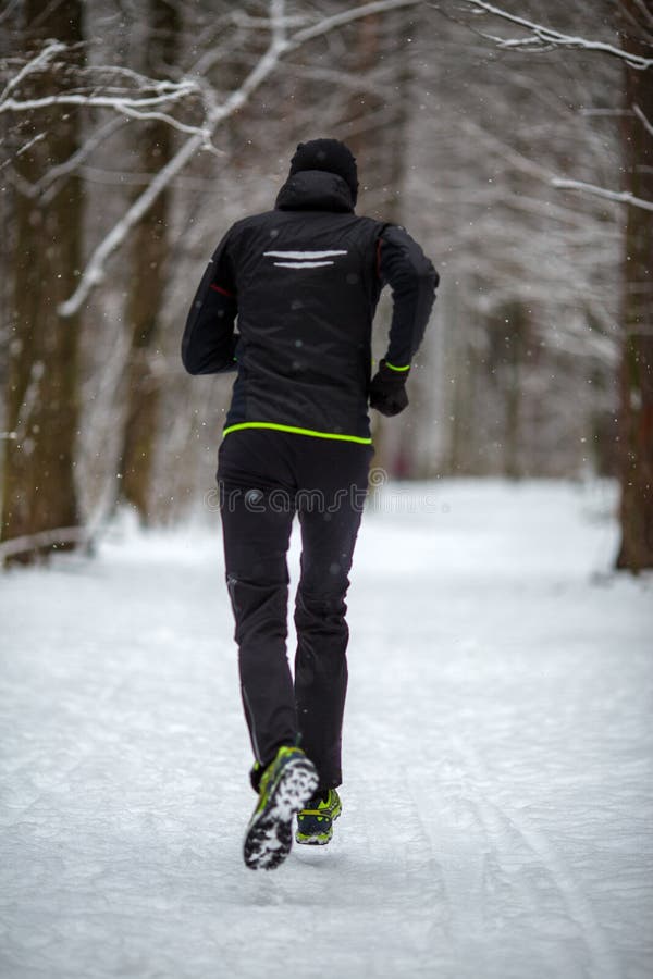 Photo from Back of Running Athlete among Trees in Winter Forest Stock ...