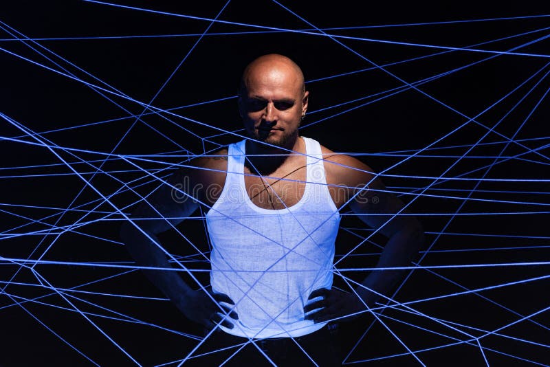 Photo of Bald Man Tangled in White Threads with Hands on Hips in ...
