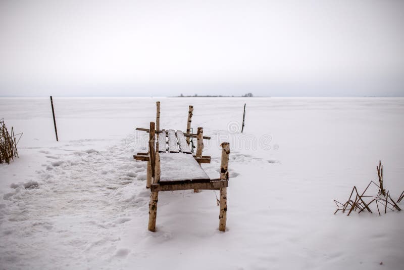 Photo of Bench Made of Birch Logs, Snowy Field Stock Photo - Image of ...