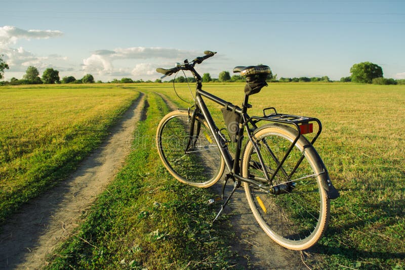 Photo of a Bicycle Standing on a Path in the Meadow Stock Image - Image ...