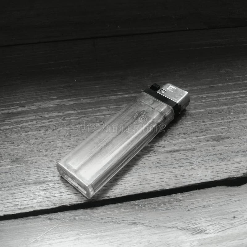 Photo of Black and White Lighter Lay Down on the Wood Table Stock Photo ...