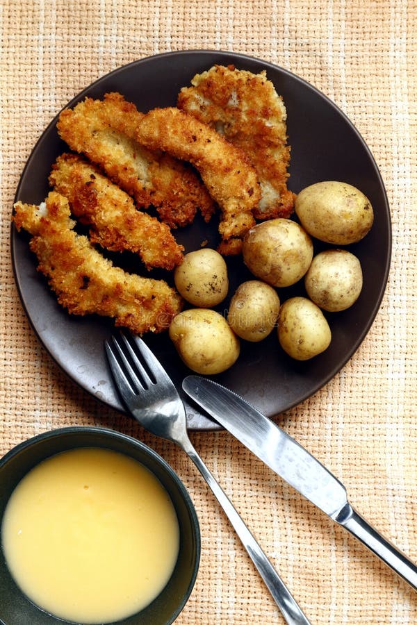 Boiled Potatoes and Deep Fried Crispy Fish Strips on a Plate Stock ...