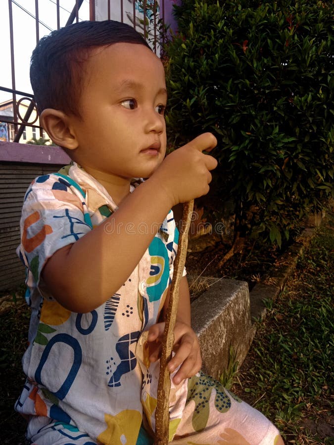 Photo of a Boy Holding a Stick and Very Cool Stock Image - Image of ...
