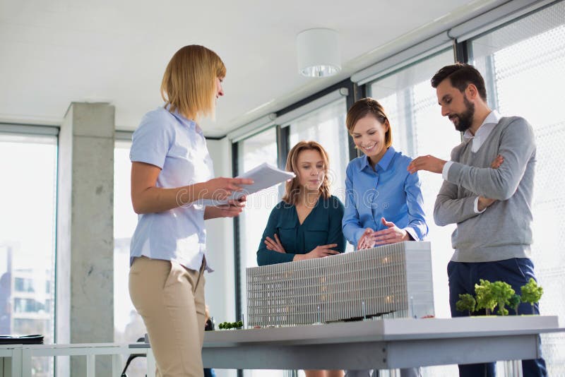 Business People Discussing Over New Building Structure Plan in Office ...