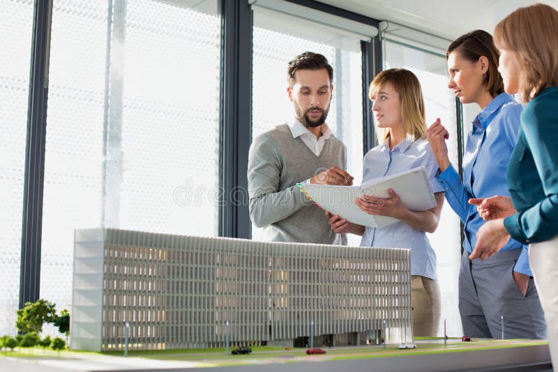 Business People Discussing Over New Building Structure Plan in Office ...