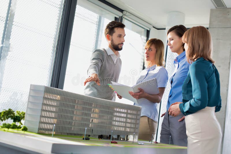 Business People Discussing Over New Building Structure Plan in Office ...