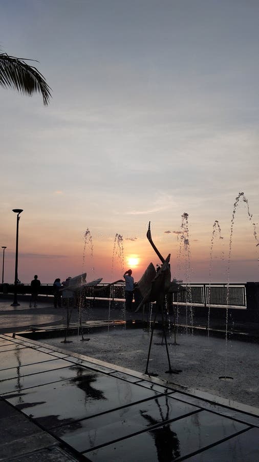 This Photo Captures a Beautiful Sunset by the Seaside, with the Sun Low ...