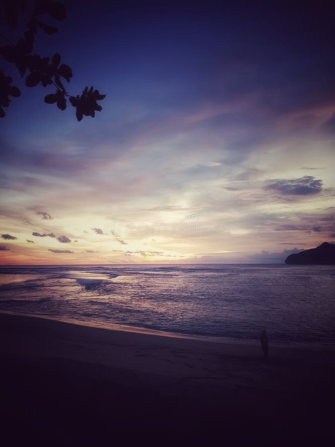 The Photo Captures a Serene Beach Scene at Dusk or Dawn. Stock Photo ...