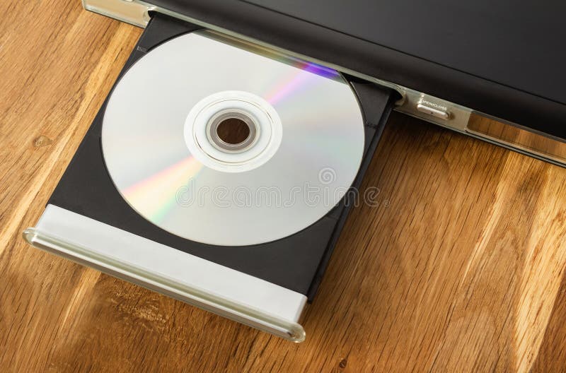 Photo of Cd or Dvd Player with Disc on Wooden Table Stock Image - Image ...
