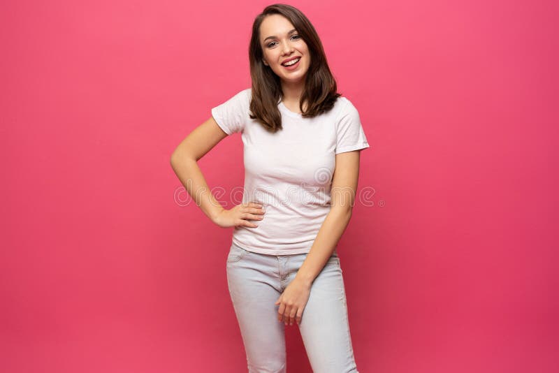 Photo Of Cheerful Beautiful Young Woman Standing Isolated Over Pink