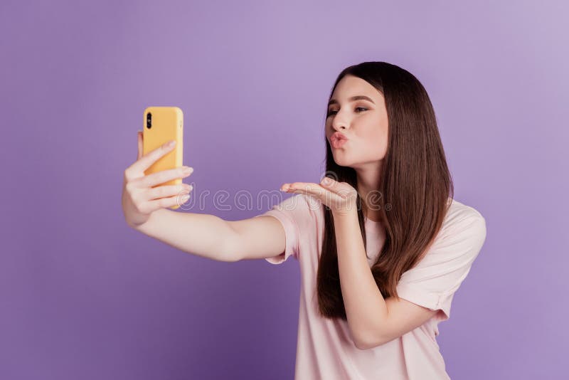 Photo Of Cheerful Cute Young Woman Hold Smartphone Take Selfie Hold